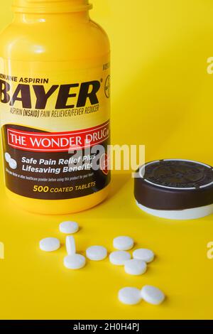 Bayer aspirin tablet container against a yellow background Stock Photo ...