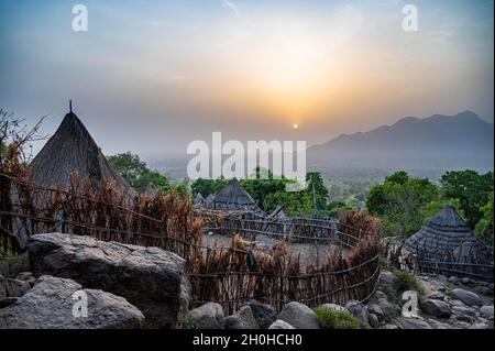 Sunset over traditional huts of the Otuho (Lotuko) tribe, Imatong ...