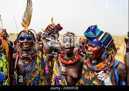 Traditional dressed women of the Jiye tribe dancing and singing ...