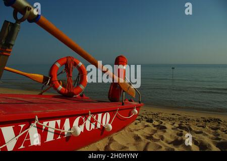 Red color rescue shoe on the beach Stock Photo - Alamy