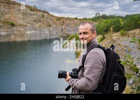 Professional photographer shooting landscape by the lakeside Stock ...