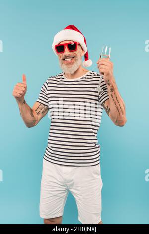 man hold champagne for xmas show thumb up in studio. xmas champagne and ...