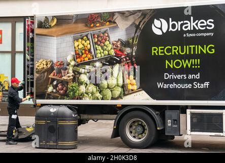 An advert for drivers and warehouse staff on the side of a lorry as a ...