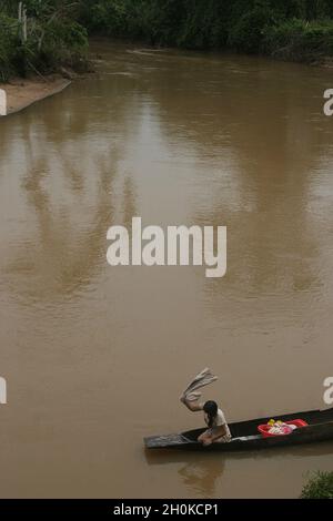 A woman from the ethnic Huaorani community, bathing in the river. The ...