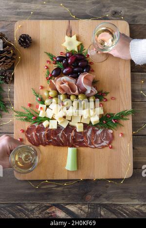 Cheese and charcuterie board in the shape of a Christmas tree. Two ...
