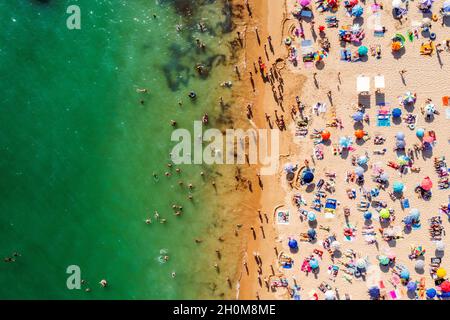 Drone shot of many people enjoying the beach and the ocean - vacation ...