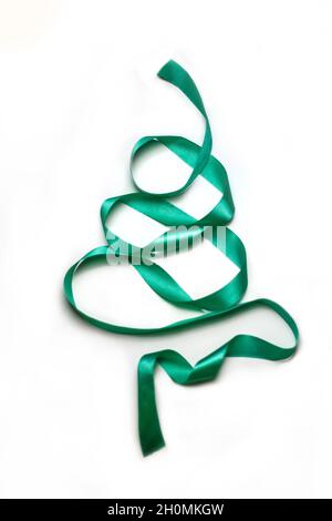 Defocus closeup Christmas tree made of bright green ribbon on white ...