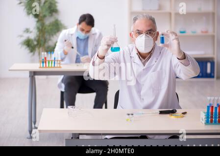 Two chemists working at the lab during pandemic Stock Photo - Alamy