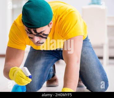 The man in military style cleaning the house Stock Photo - Alamy