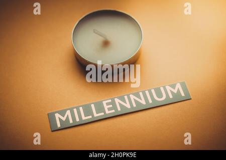 Paper with text millennium and white candle on blue table Stock Photo ...