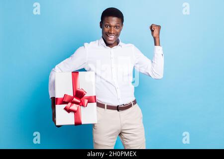 Photo of charming lucky guy dressed green t-shirt shouting rising fist ...