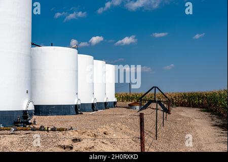 crude oil storage tanks with secondary containment and fencing in a ...