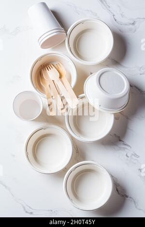 Disposable bowls and cups on wooden table, space for text Stock Photo ...