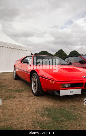Classic red BMW M1 supercar parked against a white background ...