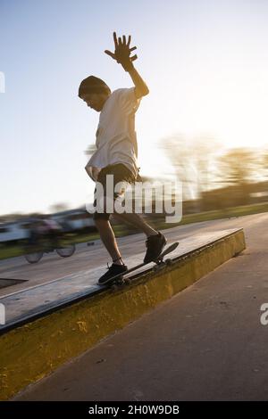 Young Argentinian male skateboarding in the park Stock Photo - Alamy