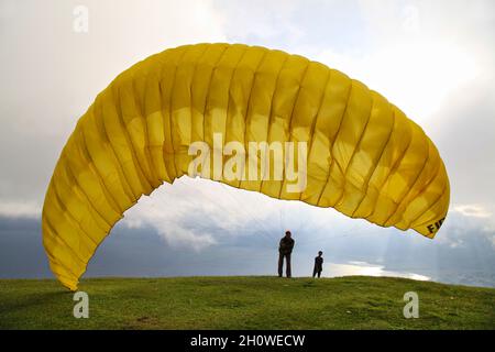 A paraglider testing his gear and wind strength at Puncak Lawang at the ...