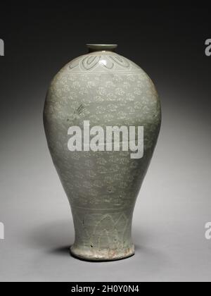 This Celadon Prunus vase features intricate inlaid designs of fish and ...