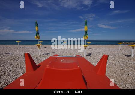 Red color rescue shoe on the beach Stock Photo - Alamy