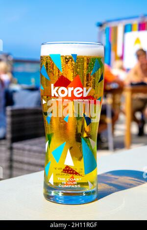 Korev Cornish beer in a glass at Surf Beach Bar, Sennen Cove, Penwith ...