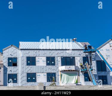 a roofer at work on a building, roof work and construction roofer at ...