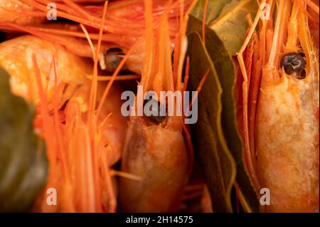 Atlantic shrimp cooked with allspice and bay leaf close-up, surface ...