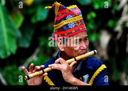 A Dusun ethnic man from Kiulu, Sabah, Malaysia, demonstrates playing ...