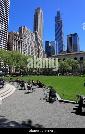 Visitors relax by the lawn of Bryant Park in midtown Manhattan.New York ...