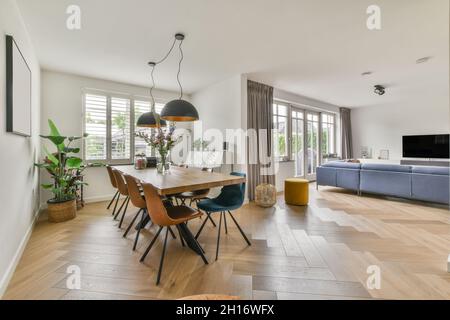 Table with chairs and sofa near lounge area ,kitchen and washing ...