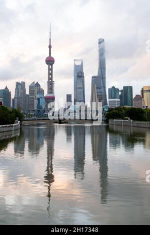 Financial district near calm river. View of skyscrapers located on ...
