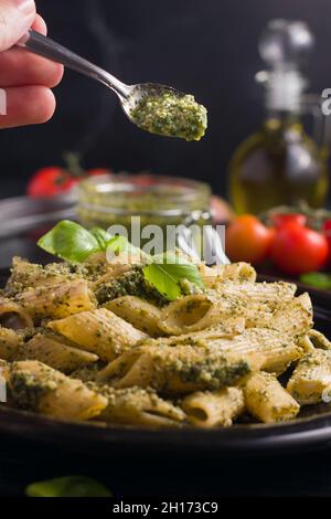 Penne pasta with pesto sauce and basil on wooden table Stock Photo - Alamy