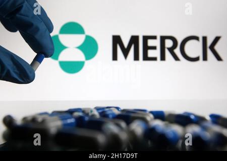 Medicine pill is seen with Merck logo and words 'Molnupiravir' and ...