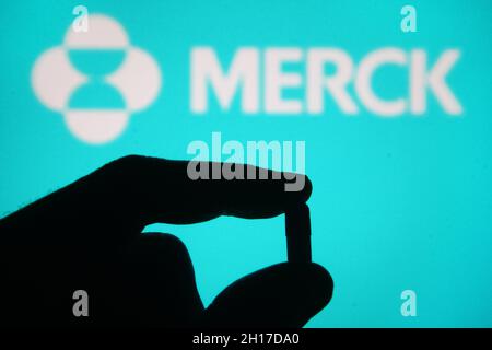 Medicine pill is seen with Merck logo and words 'Molnupiravir' and ...