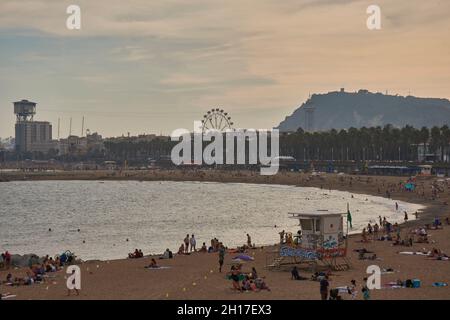 People on the Somorrostro beach during sunset, Barcelona, Catalonia ...