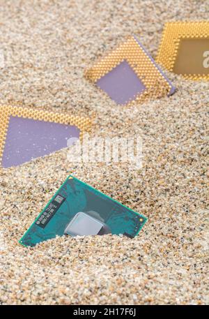 Ancient computer CPUs buried in a sandy heap for computer graveyard ...