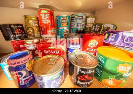 Tinned or canned foodstuffs in a UK kitchen cupboard, stocked up ...