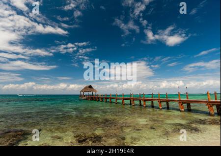 A pier and a palapa on a beach on Cozumel Island, Quintana Roo, Mexico ...
