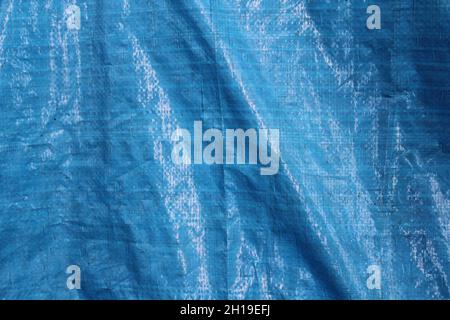 Simple blue plastic tarp, woven crumpled plain used protective ...