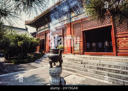 A large bronze censor of incense burner in front of the Lama Temple, a ...