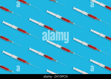 Syringe on pastel blue background from above Stock Photo - Alamy