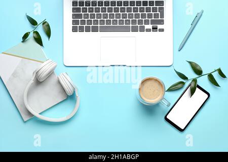 Composition with cup of coffee and modern gadgets on color background ...