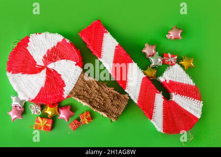 Mexican pinatas with gifts on green background with space for text ...