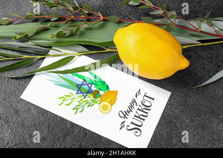 Sukkot festival symbols and greeting card on wooden background with ...
