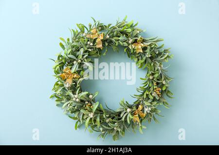 Beautiful mistletoe wreath on color wall Stock Photo - Alamy