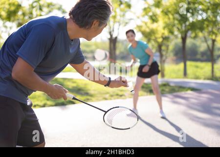 Happy mature couple playing badminton outdoors Stock Photo - Alamy