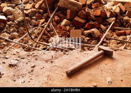 The builder breaks the old concrete floor to make a new one. Removing a ...