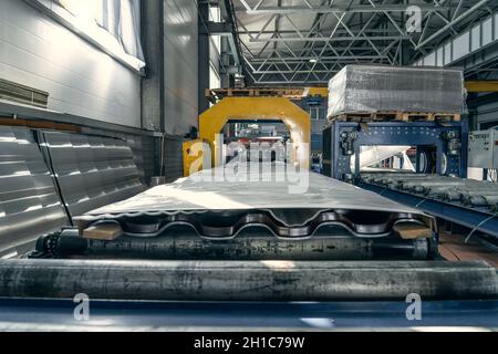 Conveyor belt or line with finished packaged metal roof tiles ...