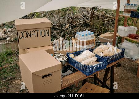 Donation box with clothes on wooden table Stock Photo - Alamy