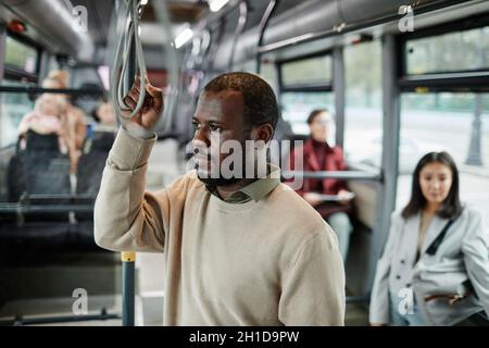 man holding bus handle Stock Photo - Alamy