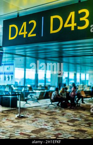 Interior of airport terminal with the sign depicting gate number Stock ...