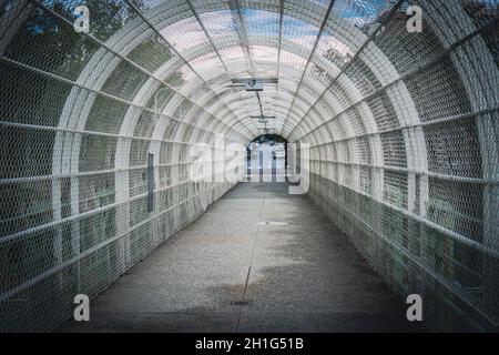 Enclosed pedestrian footbridge with steel safety cage, over m60 ...